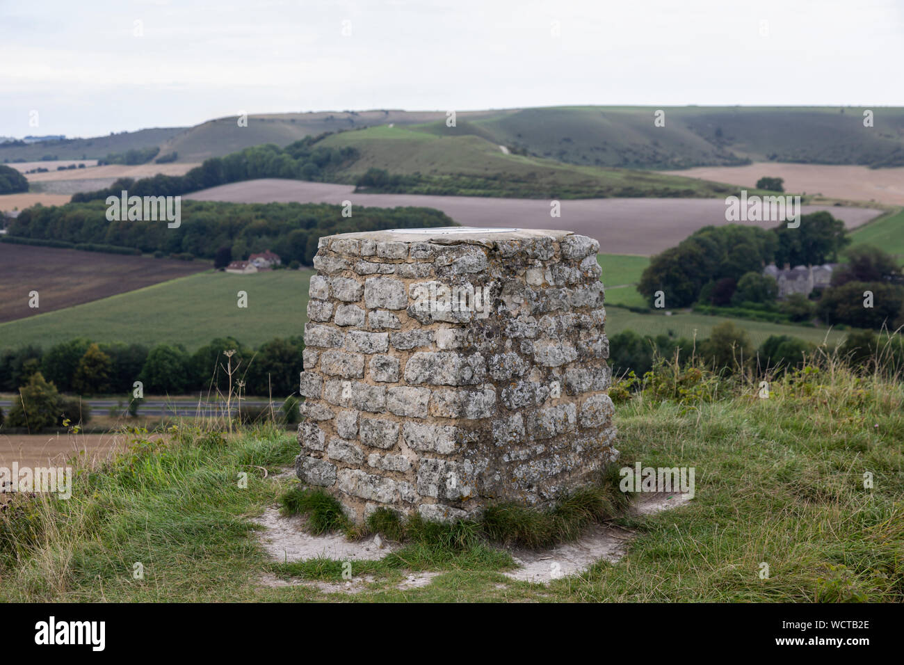Stone plinth with a circular direction guide in km to various places ...