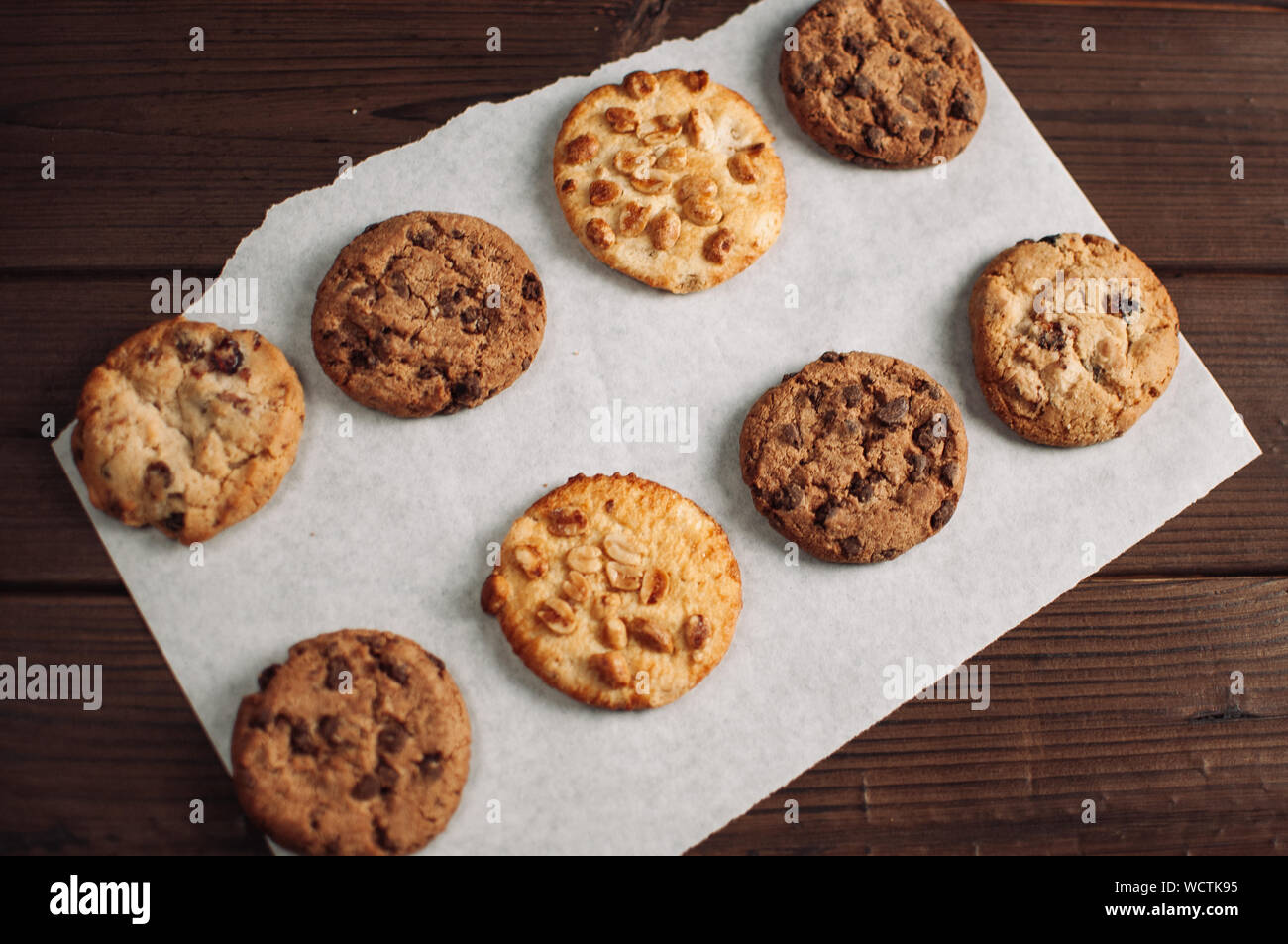 Chocolate covered cookies lay on a parchment paper in a row. Gluten ...