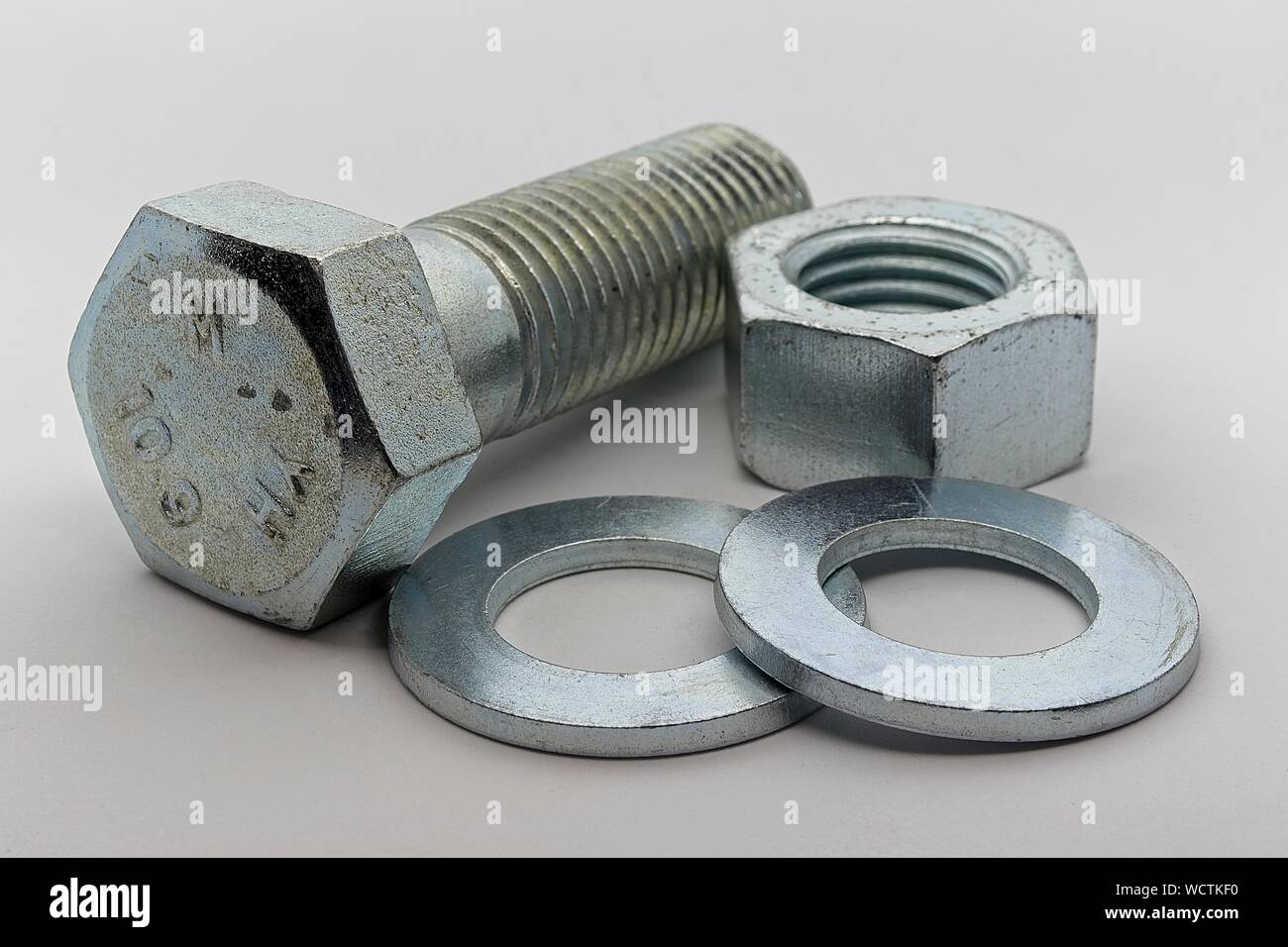 Steel nut, bolt and washers on white background Stock Photo - Alamy