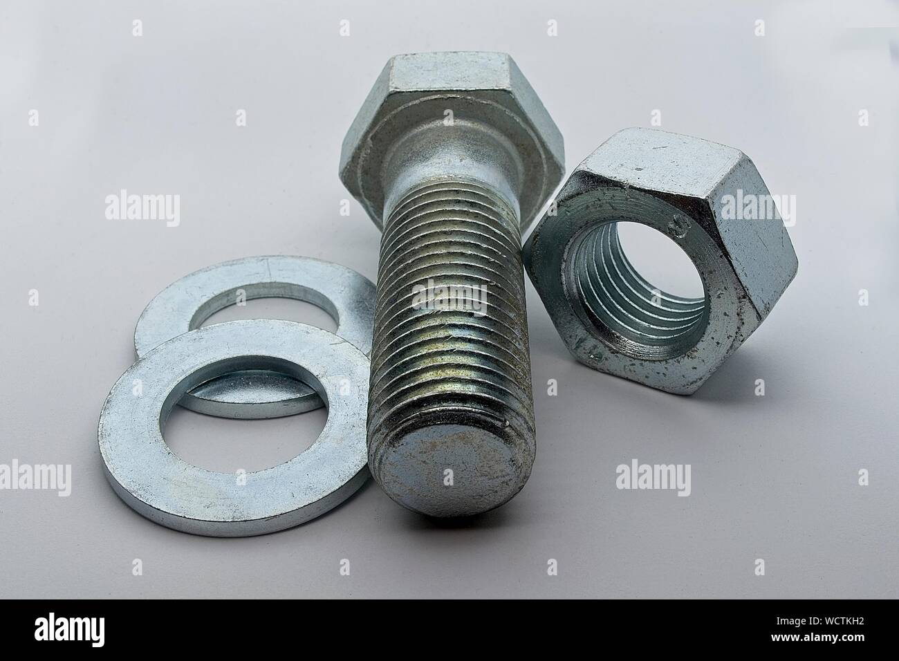 Steel nut, bolt and washers on white background Stock Photo - Alamy