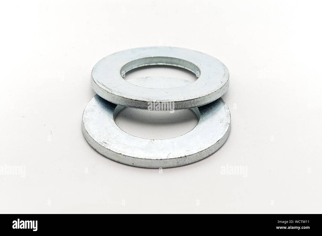 Steel nut, bolt and washers on white background Stock Photo - Alamy