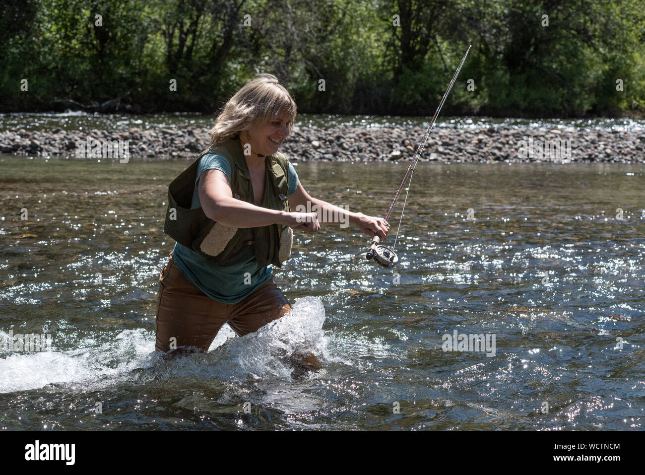 Woman wading in river hi-res stock photography and images - Alamy