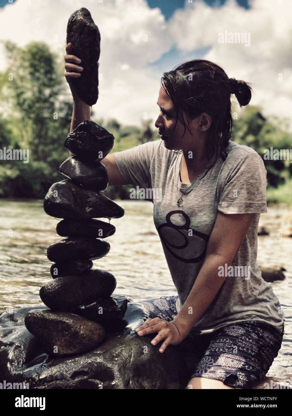 Woman stacking stones hi-res stock photography and images - Alamy