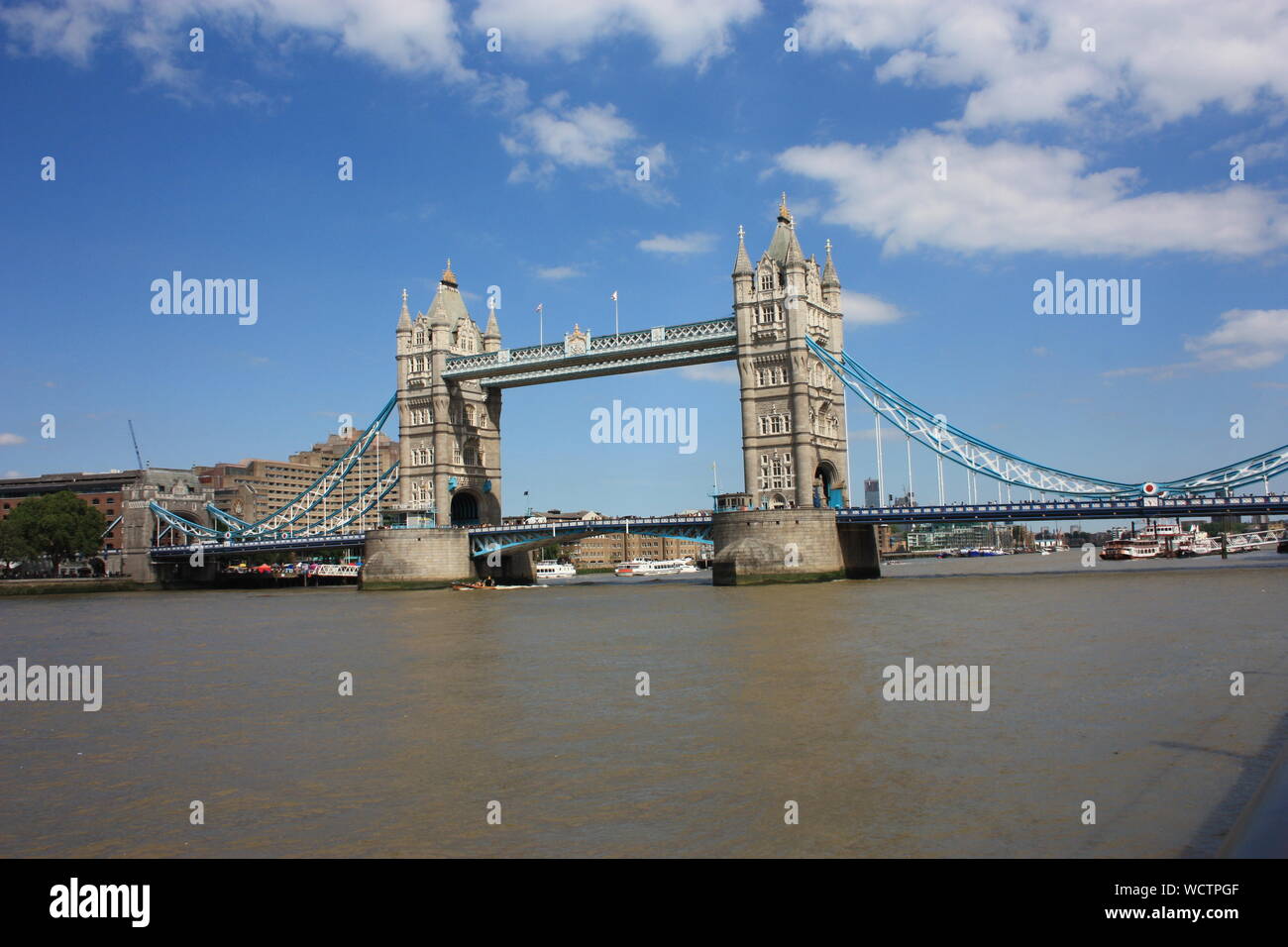 The famous London Bridge on a blue sky summer day. The tranquil water ...