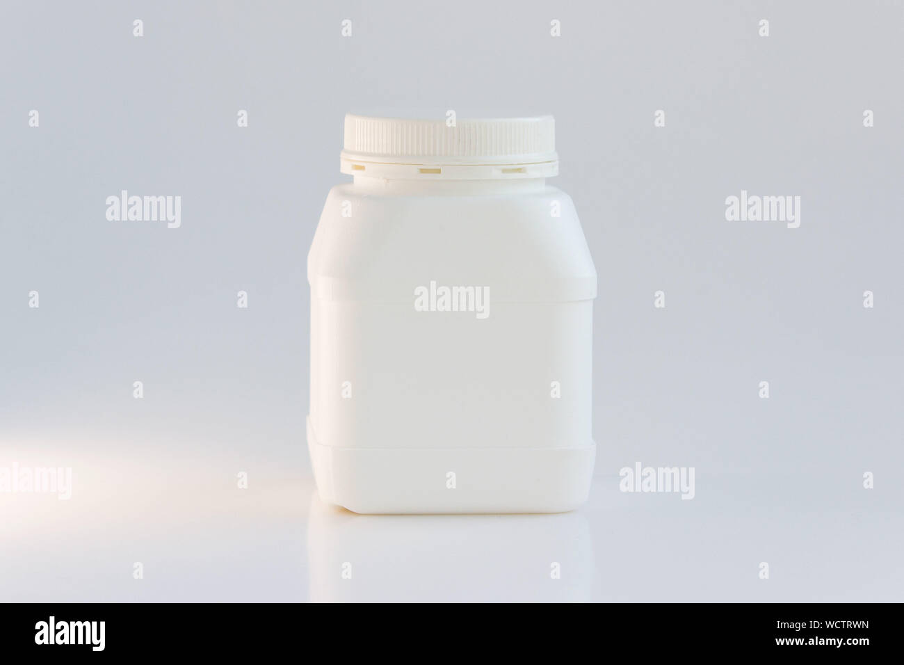 white plastic jar with lid on a white background Stock Photo - Alamy