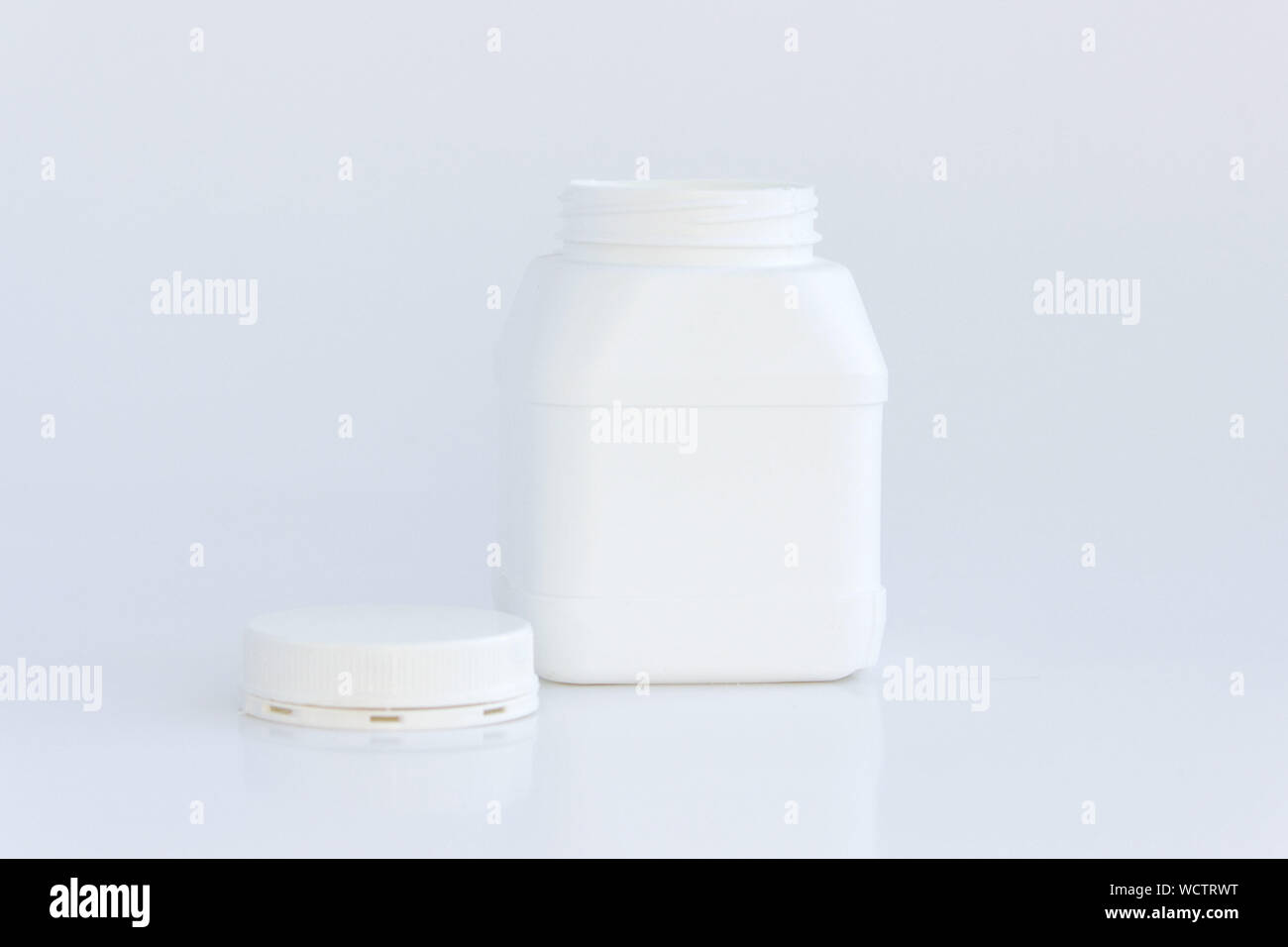 white plastic jar with lid on a white background Stock Photo - Alamy