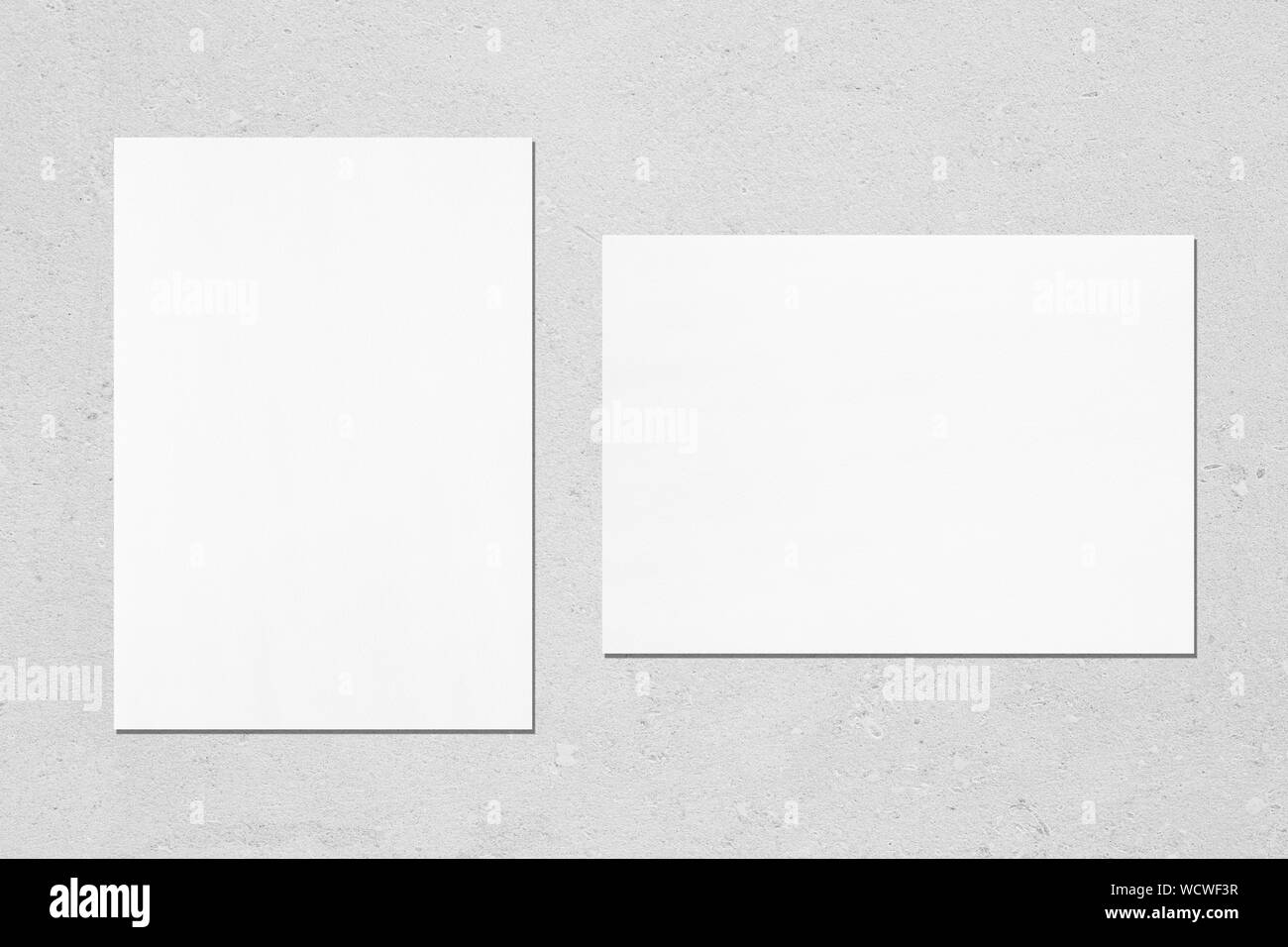 Two empty white vertical and horizontal rectangle poster mockups with ...
