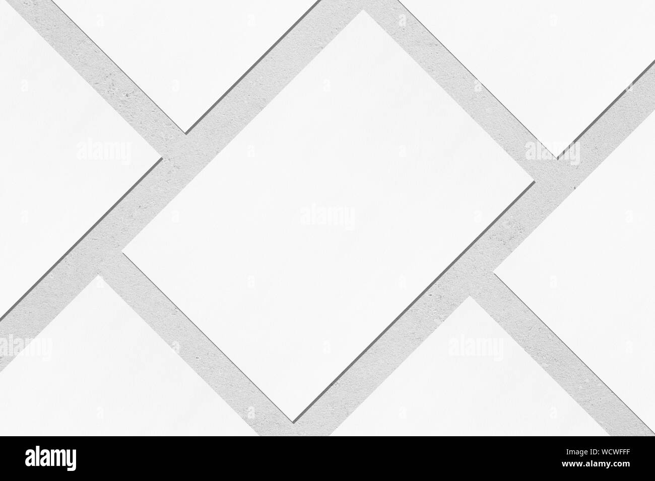 Close up of empty white rectangle poster mockups lying diagonally with ...
