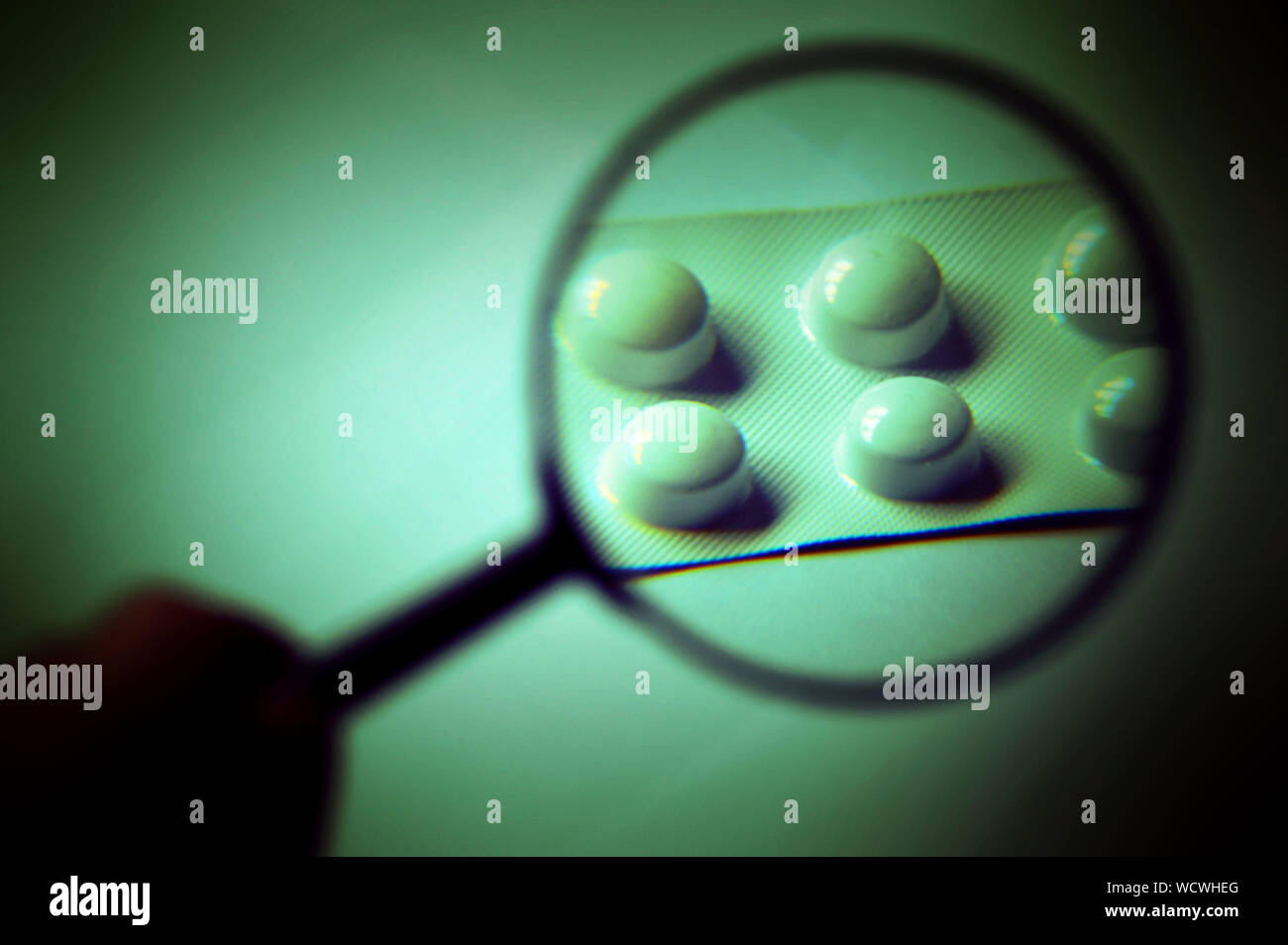 Magnifying glass and pills hi-res stock photography and images - Alamy