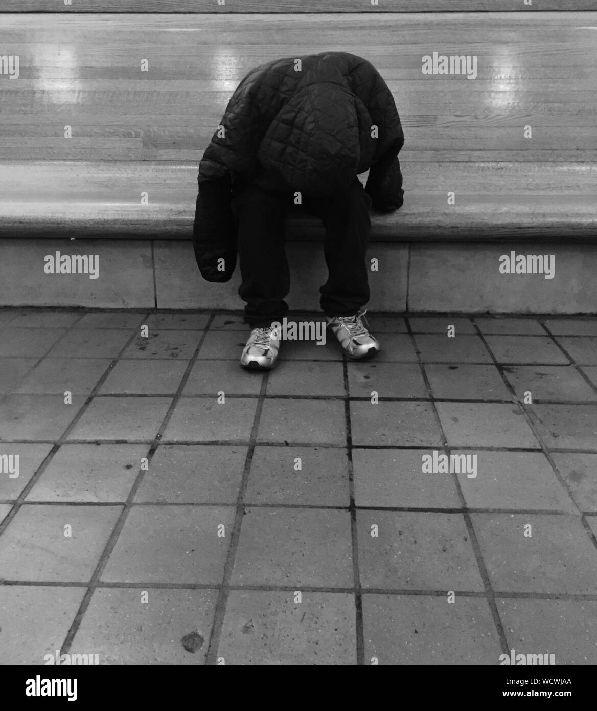 Homeless person sitting on the street hi-res stock photography and ...