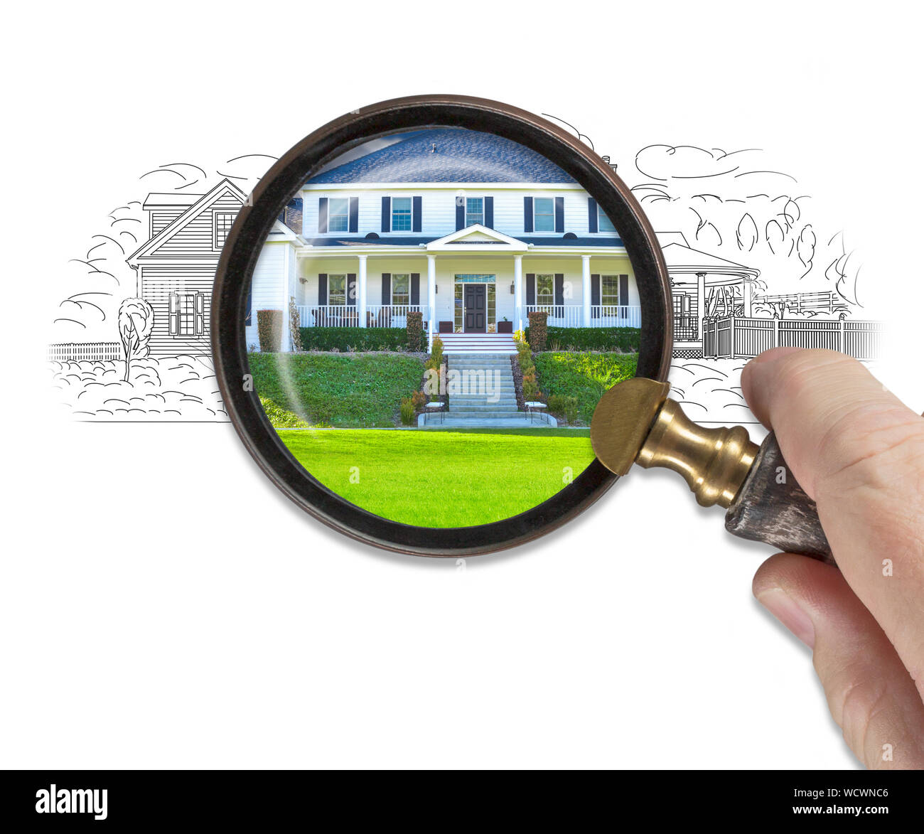 Hand Holding Magnifying Glass Revealing Finished House Build Over ...