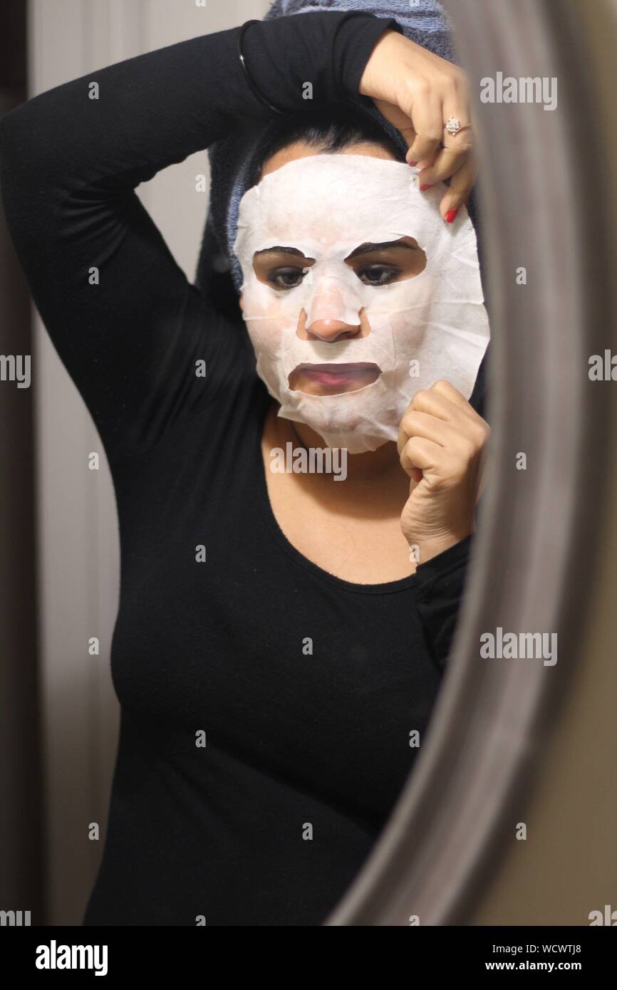 Removing the mask hi-res stock photography and images - Alamy