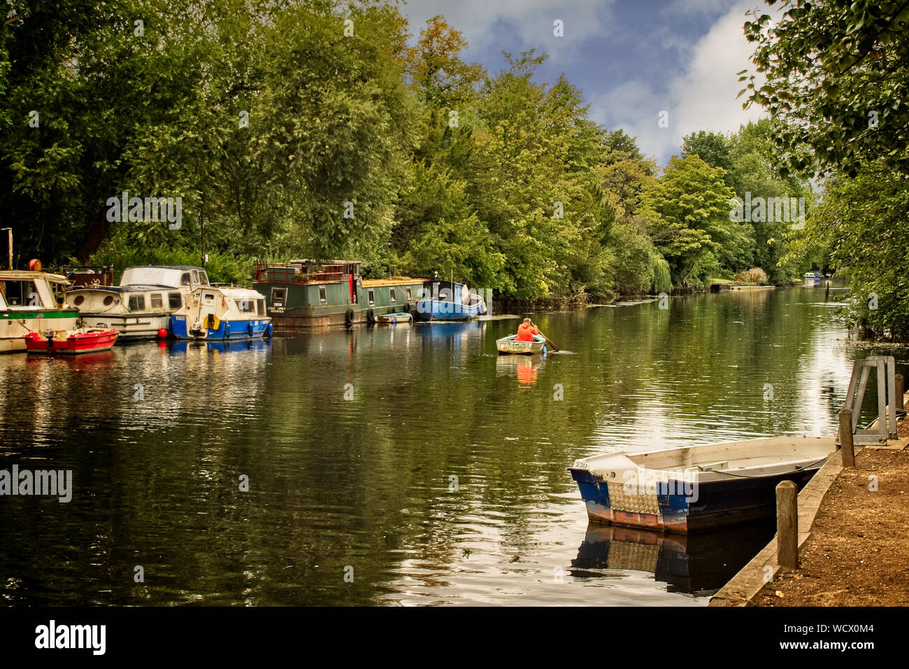 Boats moored on river Bure near Norwich in Norfolk, on a nice day in ...