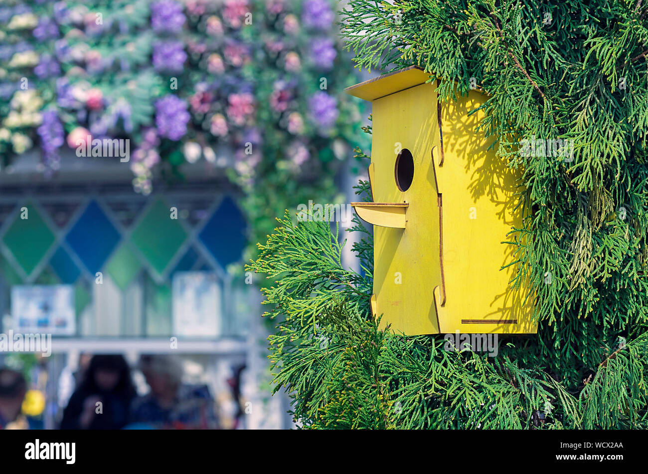 Wooden yellow birdhouse on a tree. House for birds handmade Stock Photo ...