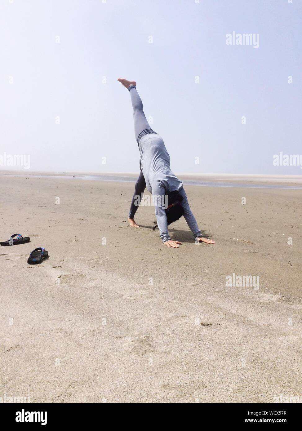 Woman handstand beach sand hi-res stock photography and images - Alamy