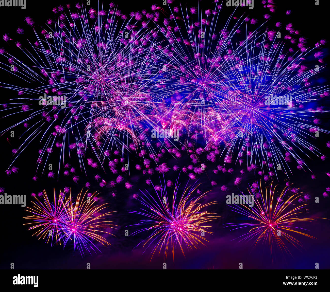 Colorful fireworks in night sky background Stock Photo - Alamy