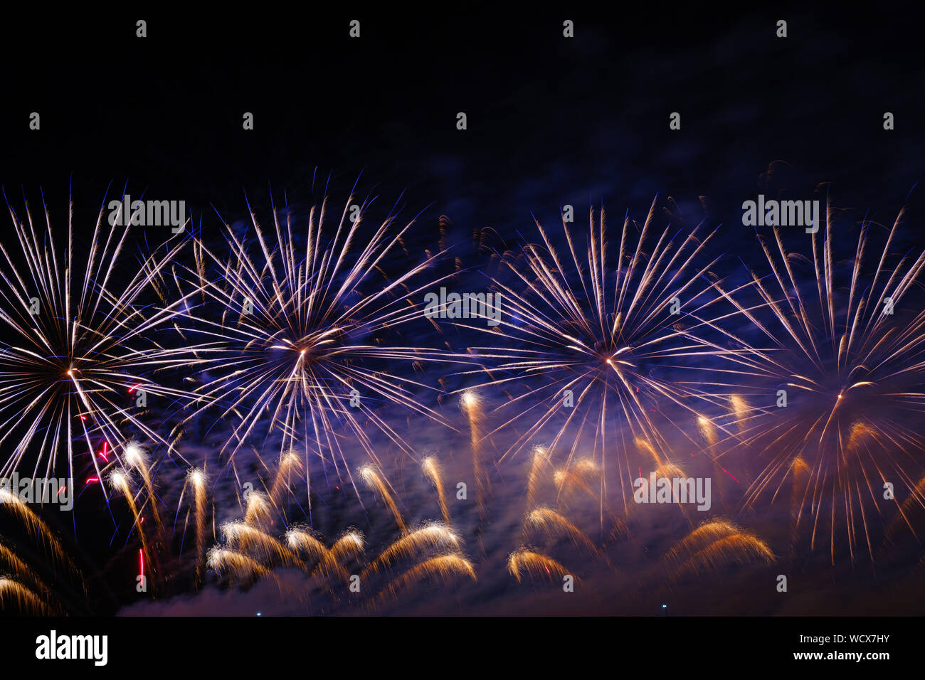 Colorful fireworks in night sky background Stock Photo - Alamy