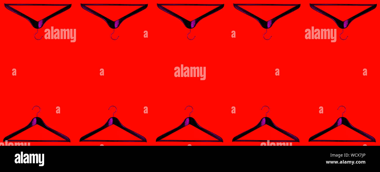 Fashion clothes hanger pattern on red background Stock Photo - Alamy