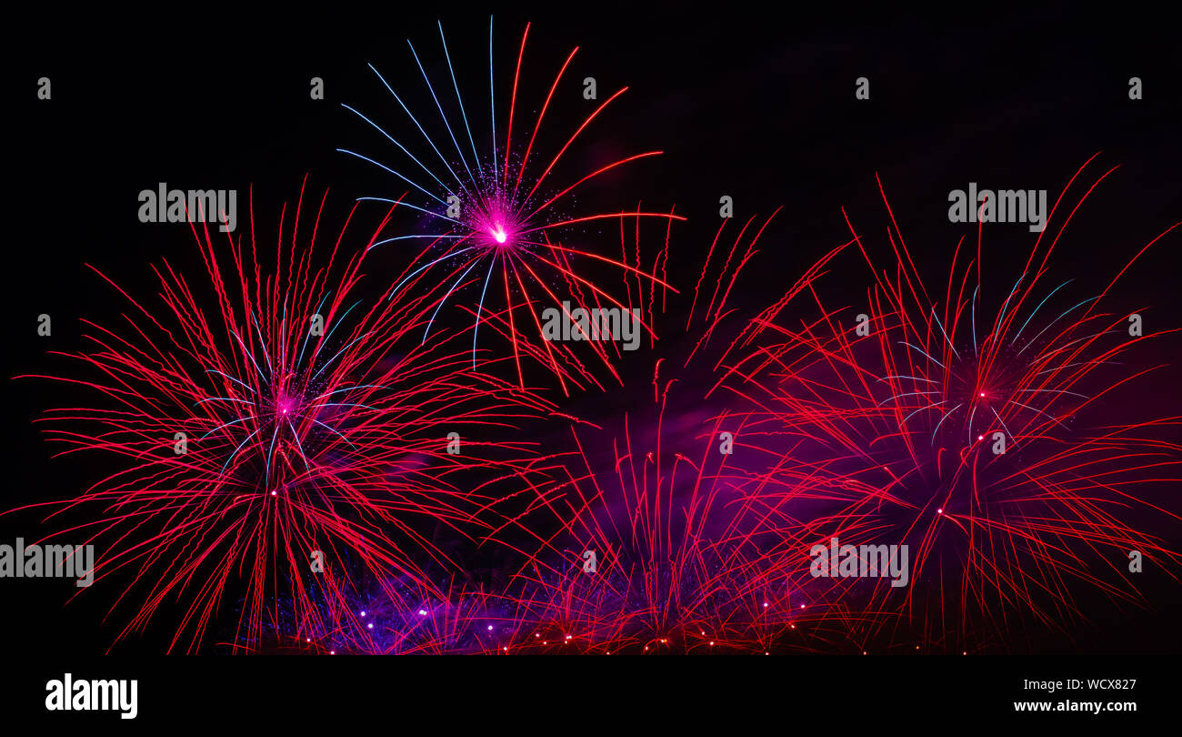Colorful fireworks in night sky background Stock Photo - Alamy