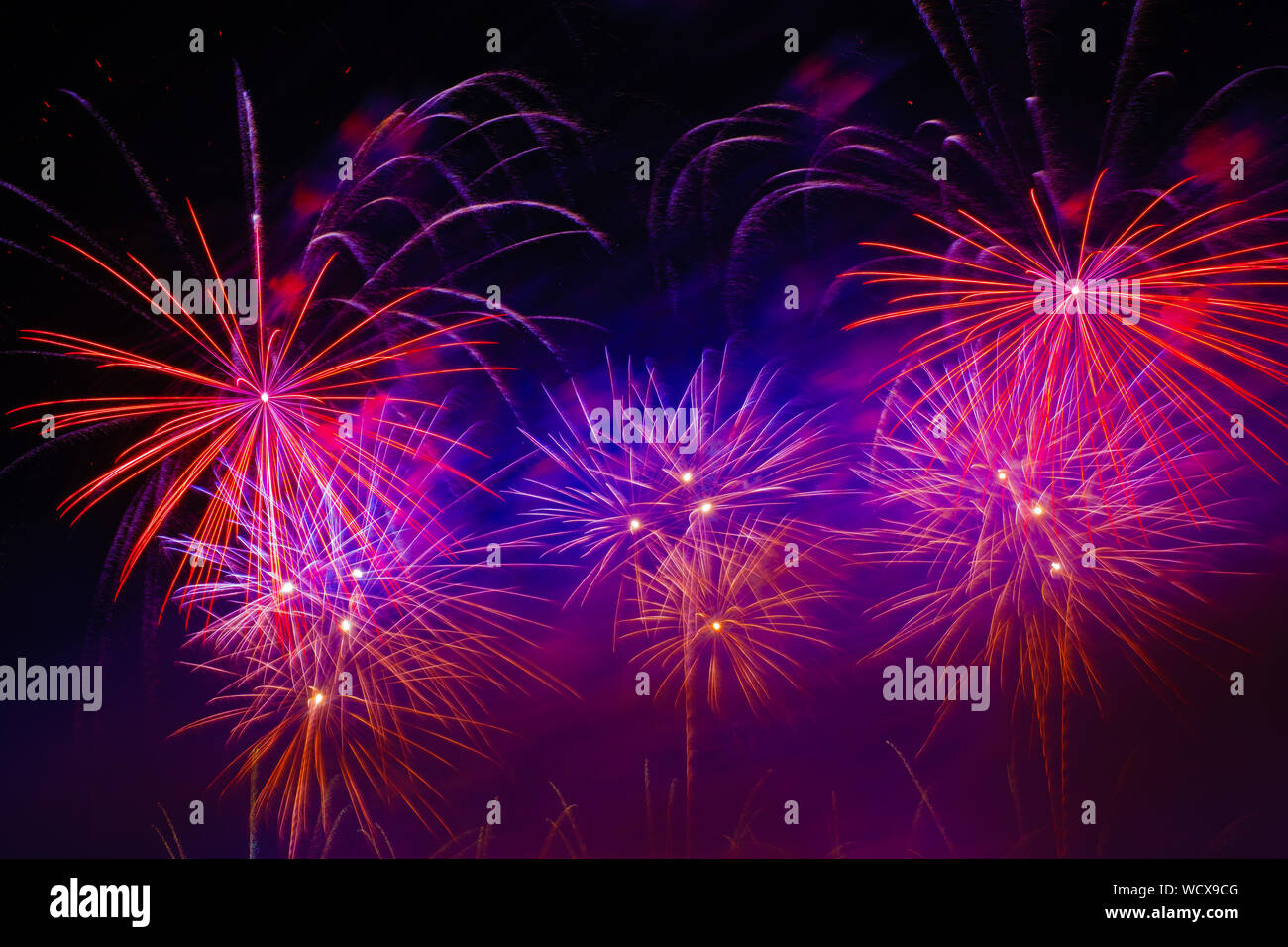 Colorful fireworks in night sky background Stock Photo - Alamy
