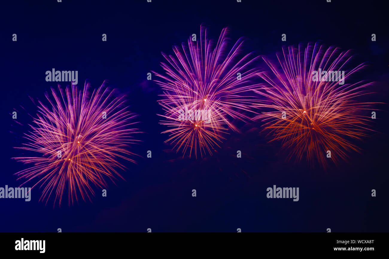 Colorful fireworks in night sky background Stock Photo - Alamy