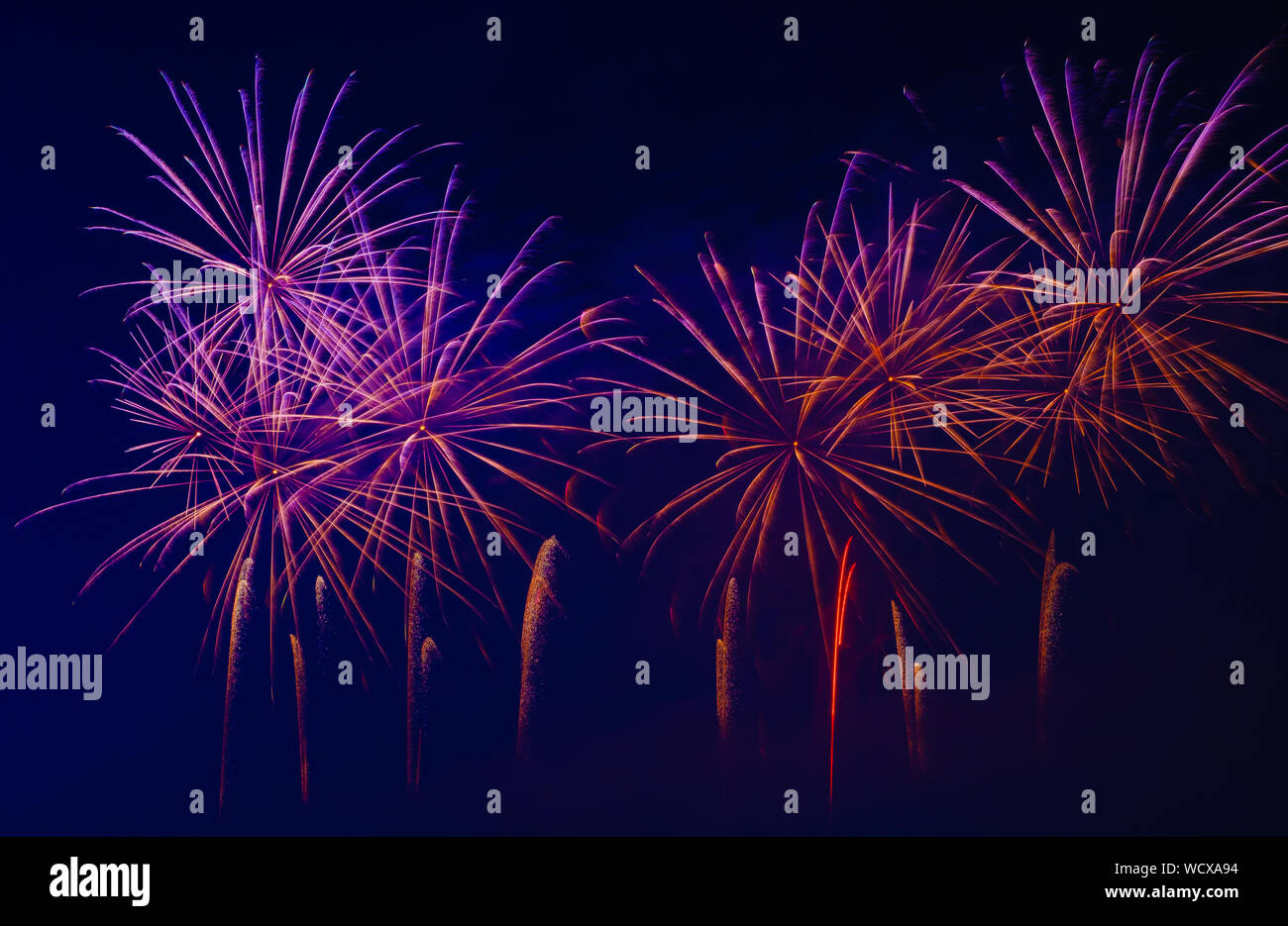 Colorful fireworks in night sky background Stock Photo - Alamy