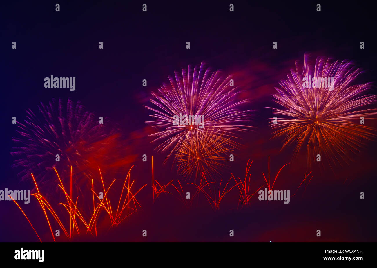 Colorful fireworks in night sky background Stock Photo - Alamy