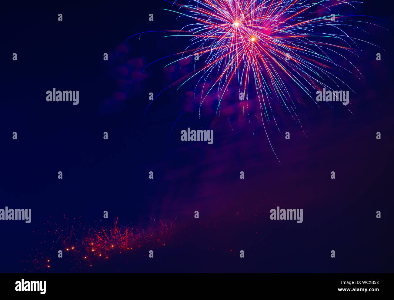 Colorful fireworks in night sky background Stock Photo - Alamy