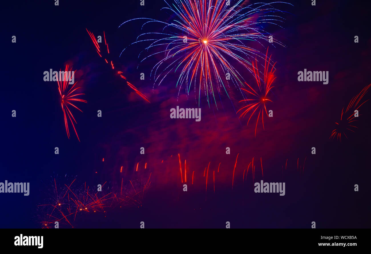 Colorful fireworks in night sky background Stock Photo - Alamy