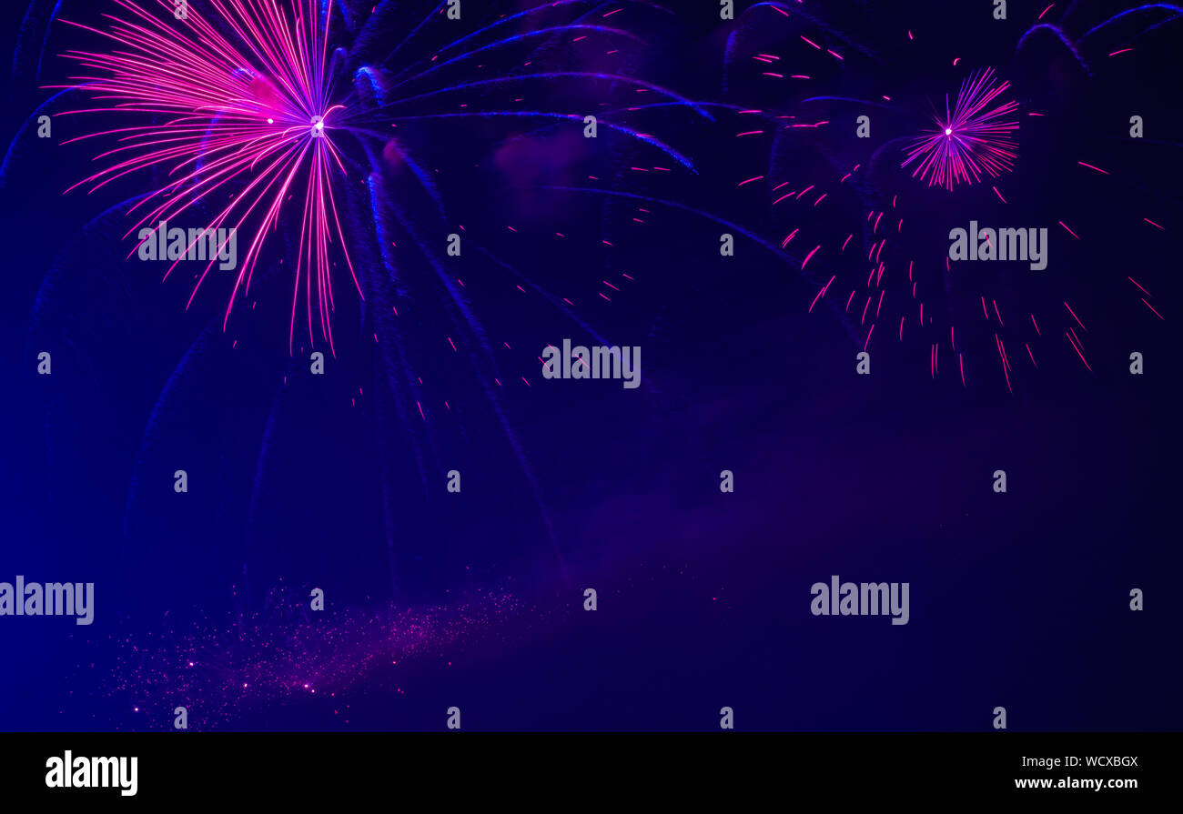 Colorful fireworks in night sky background Stock Photo - Alamy