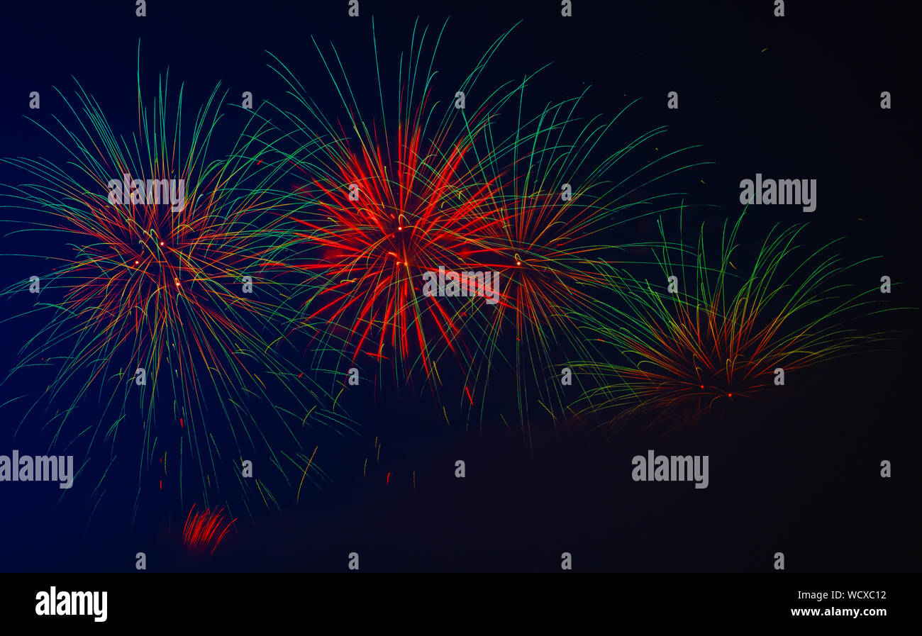 Colorful fireworks in night sky background Stock Photo - Alamy