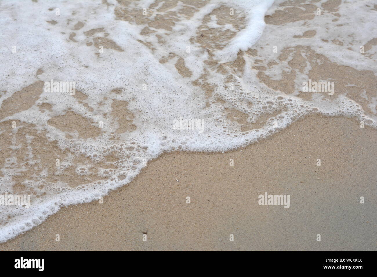 Beautiful soft waves of Blue Ocean with Sandy Beach Background close up ...