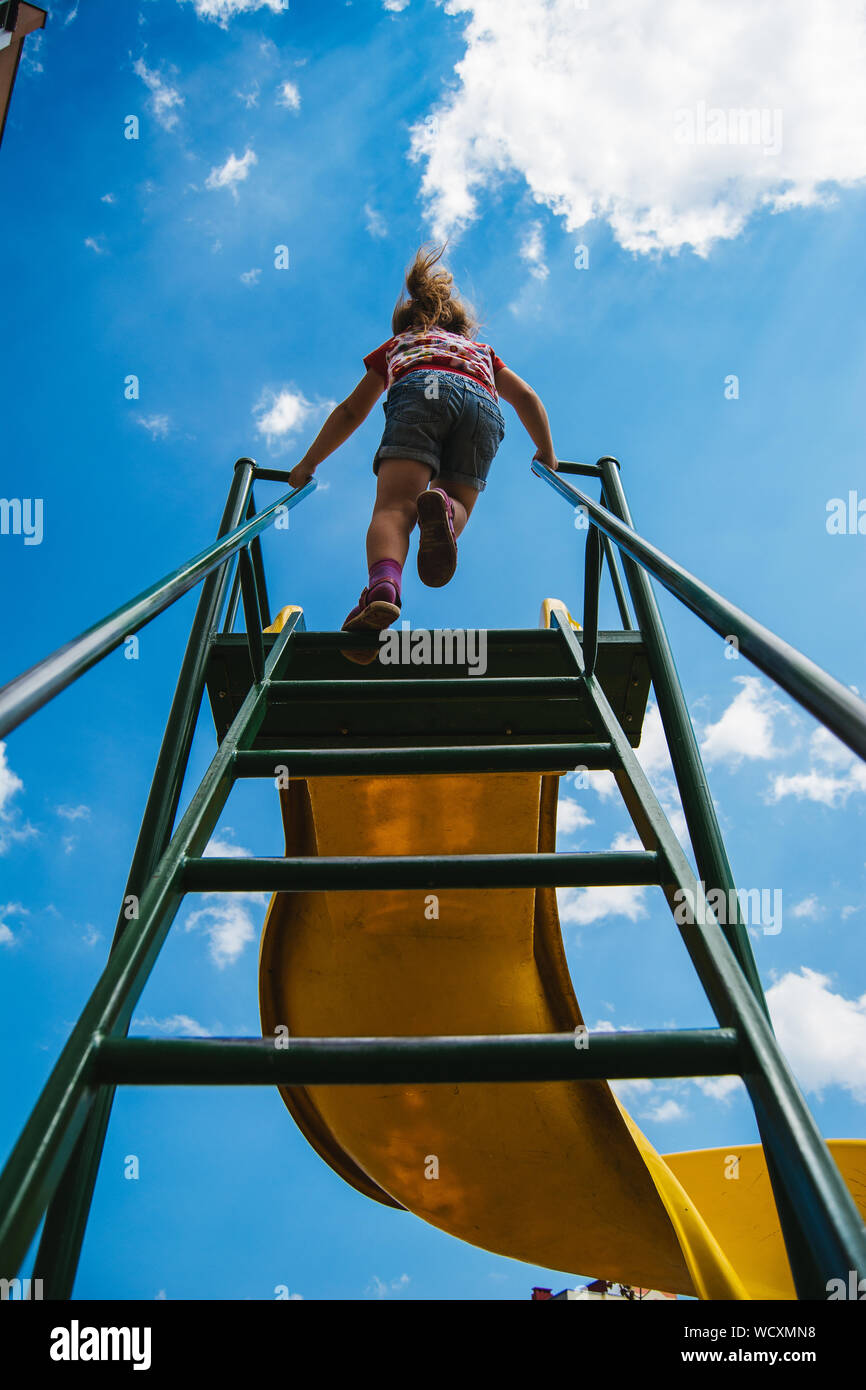 Child on slide hi-res stock photography and images - Alamy