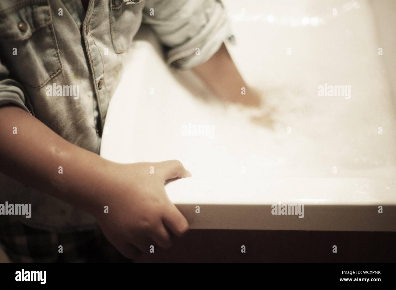 Boy in sink hi-res stock photography and images - Alamy