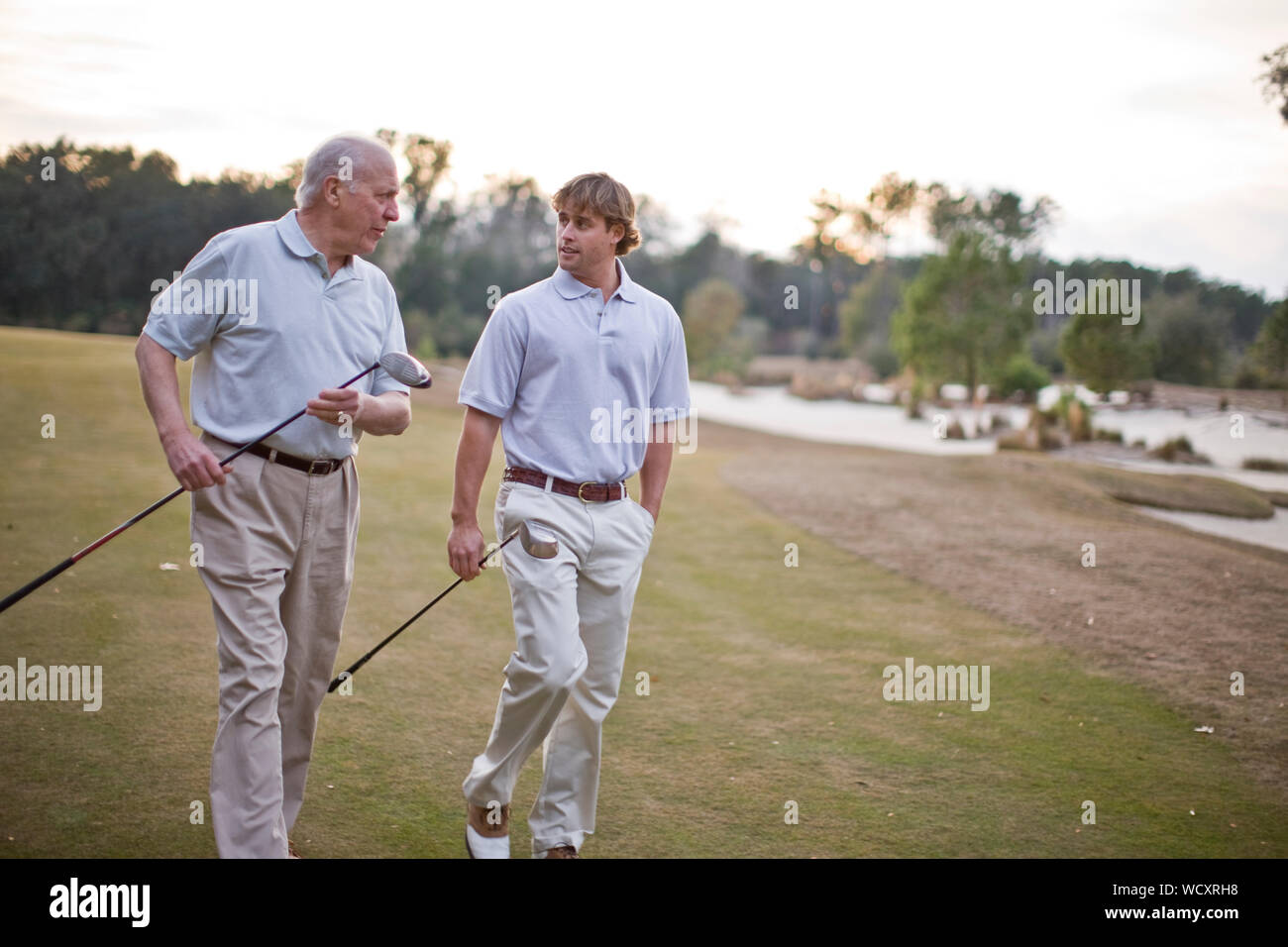 Father and adult son playing golf Stock Photo - Alamy