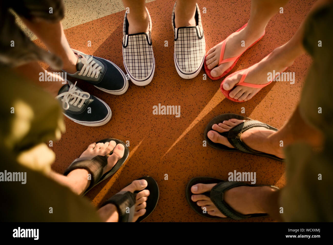 Various types of shoes being worn by a group of people Stock Photo - Alamy