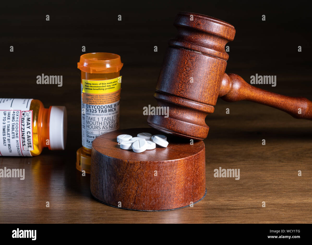 Oxycodone opioid tablets with judge gavel for court decision about ...