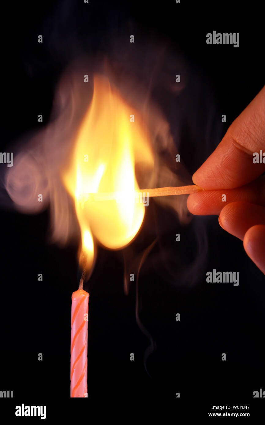 Hand holding lit match black hi-res stock photography and images - Alamy