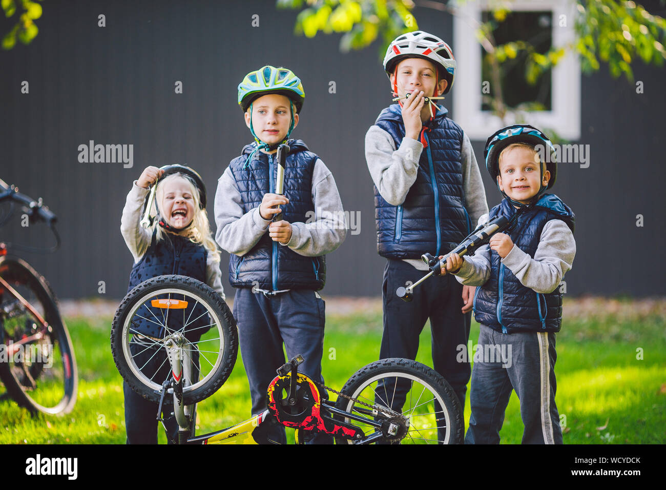 Children mechanics, bicycle repair. Happy kids fixing bike together ...