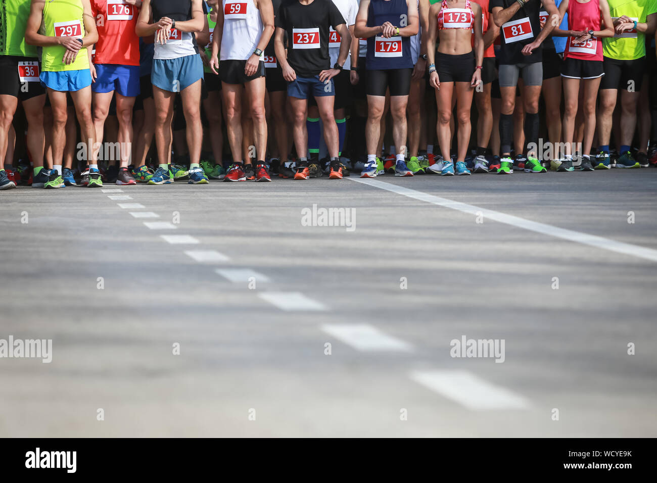 A front view of people standing lined up at the half marathon event ...