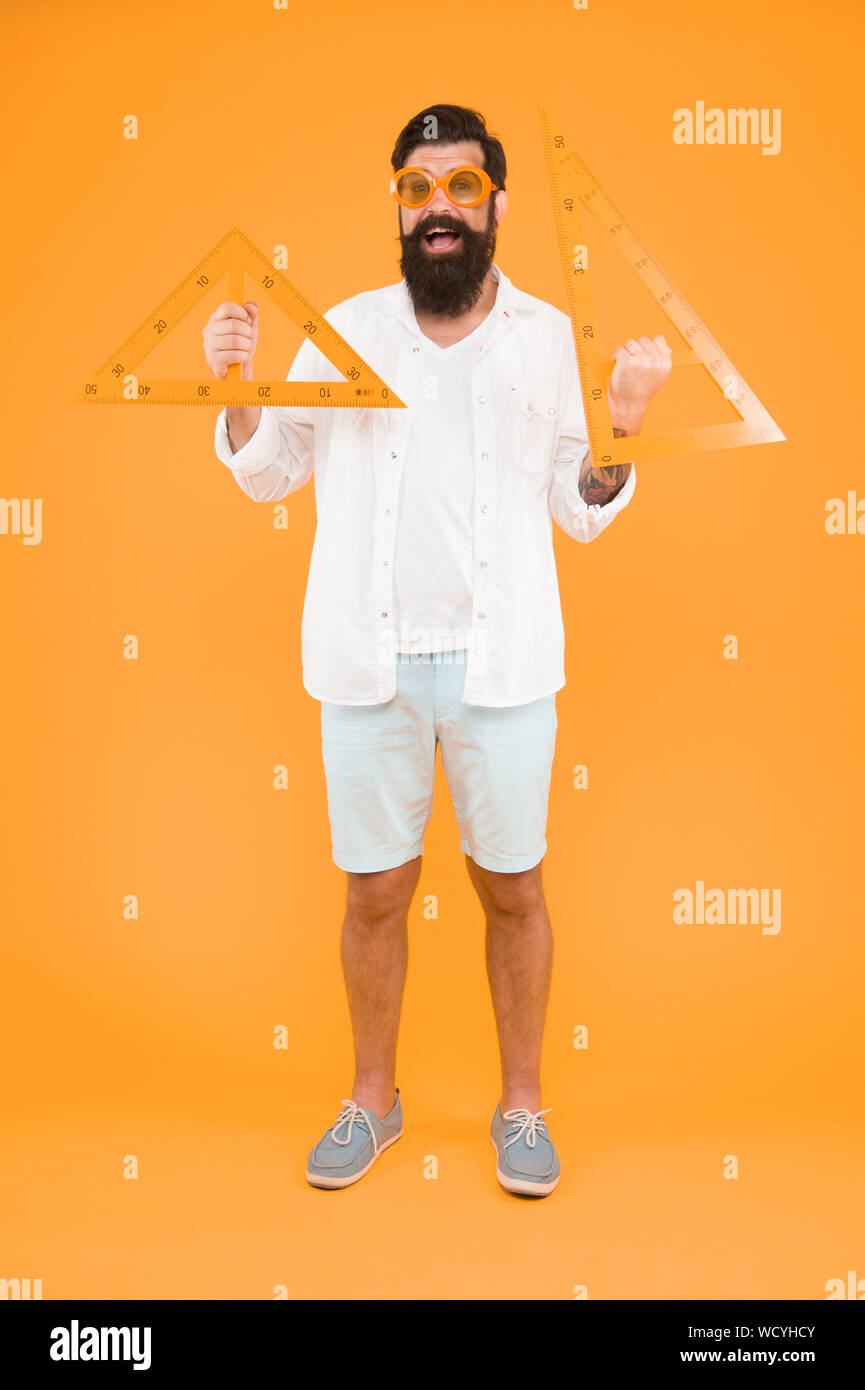 Measuring angles at geometry. Geometry teacher holding triangles for ...