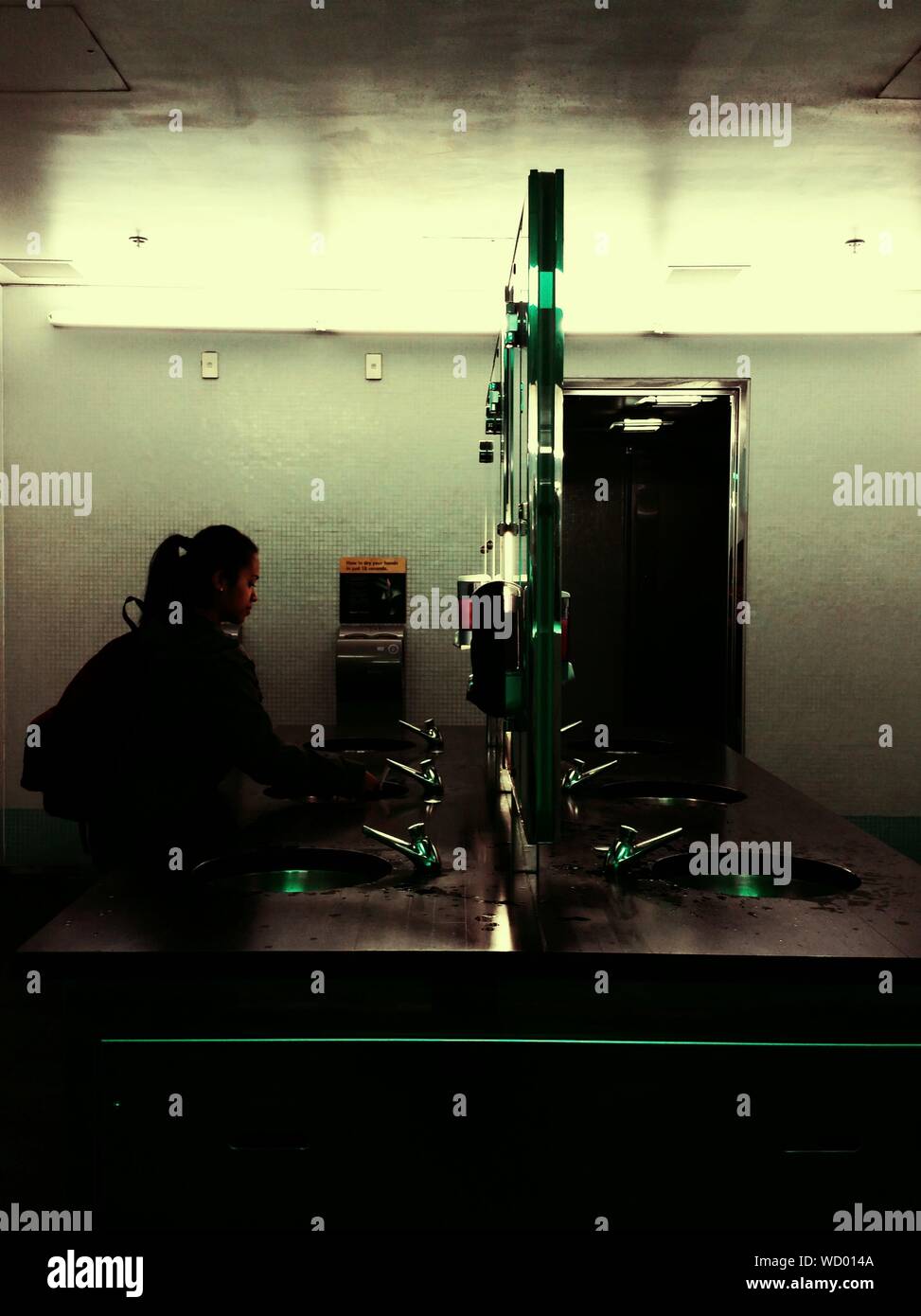 Person in restroom hi-res stock photography and images - Alamy