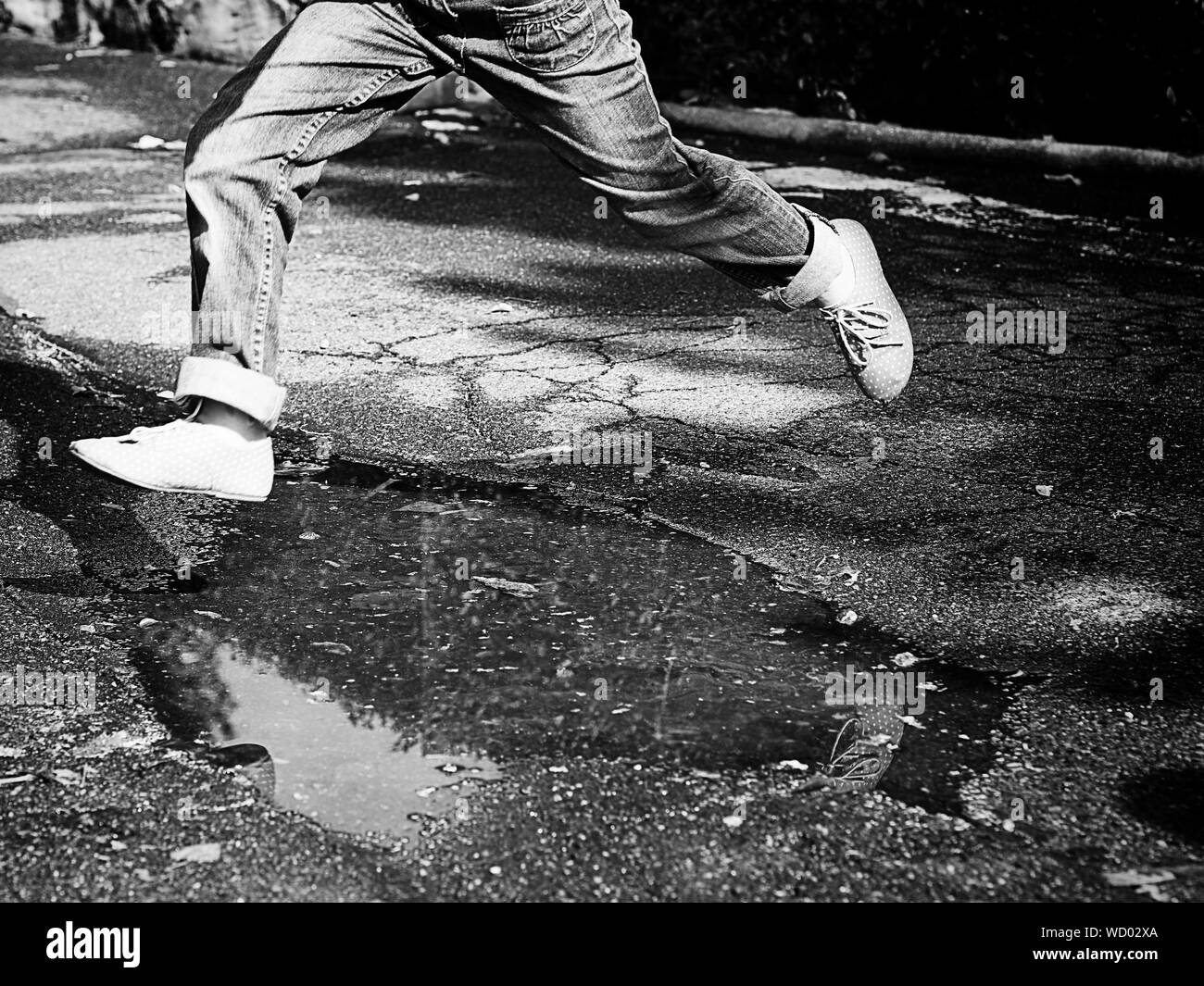 Jumping water puddle Black and White Stock Photos & Images - Alamy