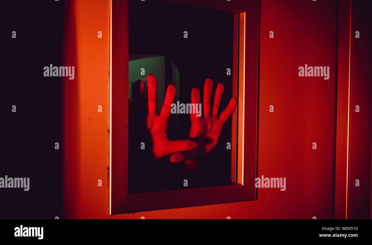Hands pressed against window hi-res stock photography and images - Alamy