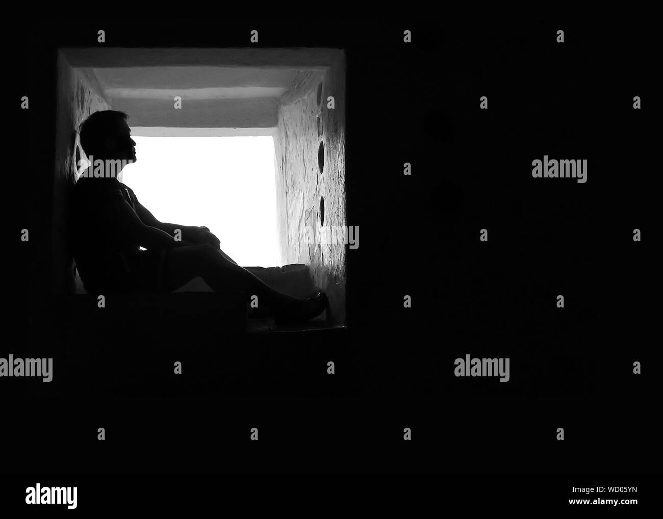Silhouette Man Sitting At Window Stock Photo - Alamy