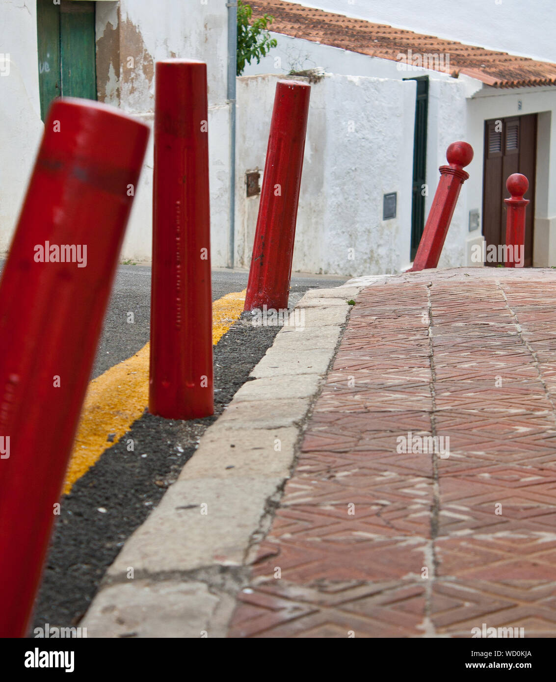 Red Bollards On Street Against Building Stock Photo - Alamy