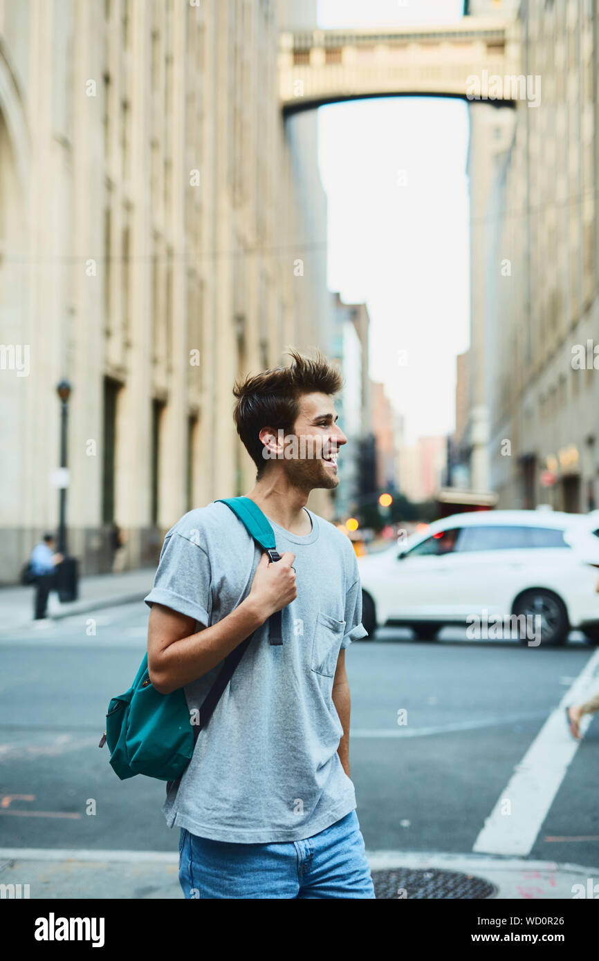 Young man walking the city hi-res stock photography and images - Alamy