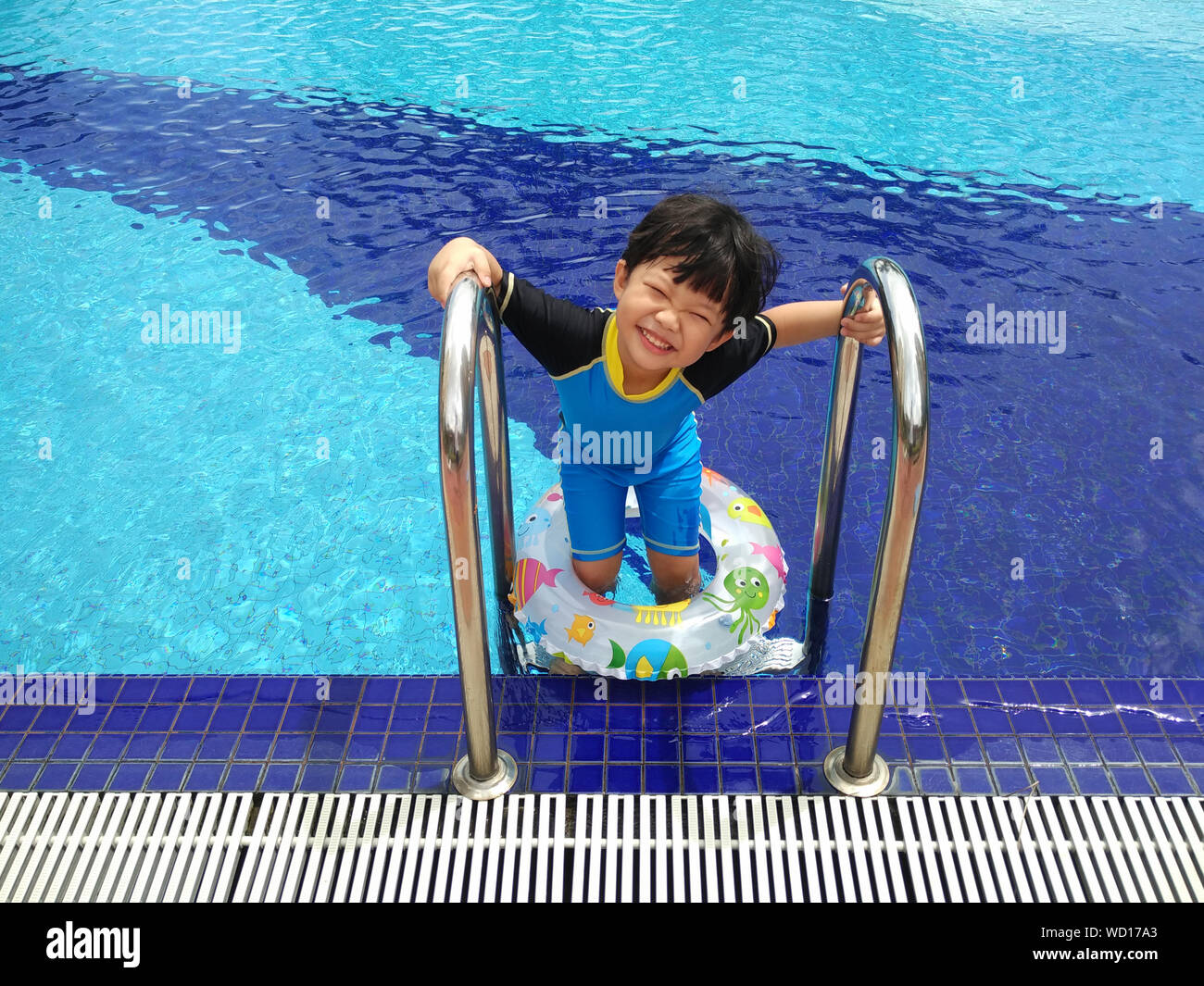Boy Playing In Swimming Pool Stock Photo - Alamy