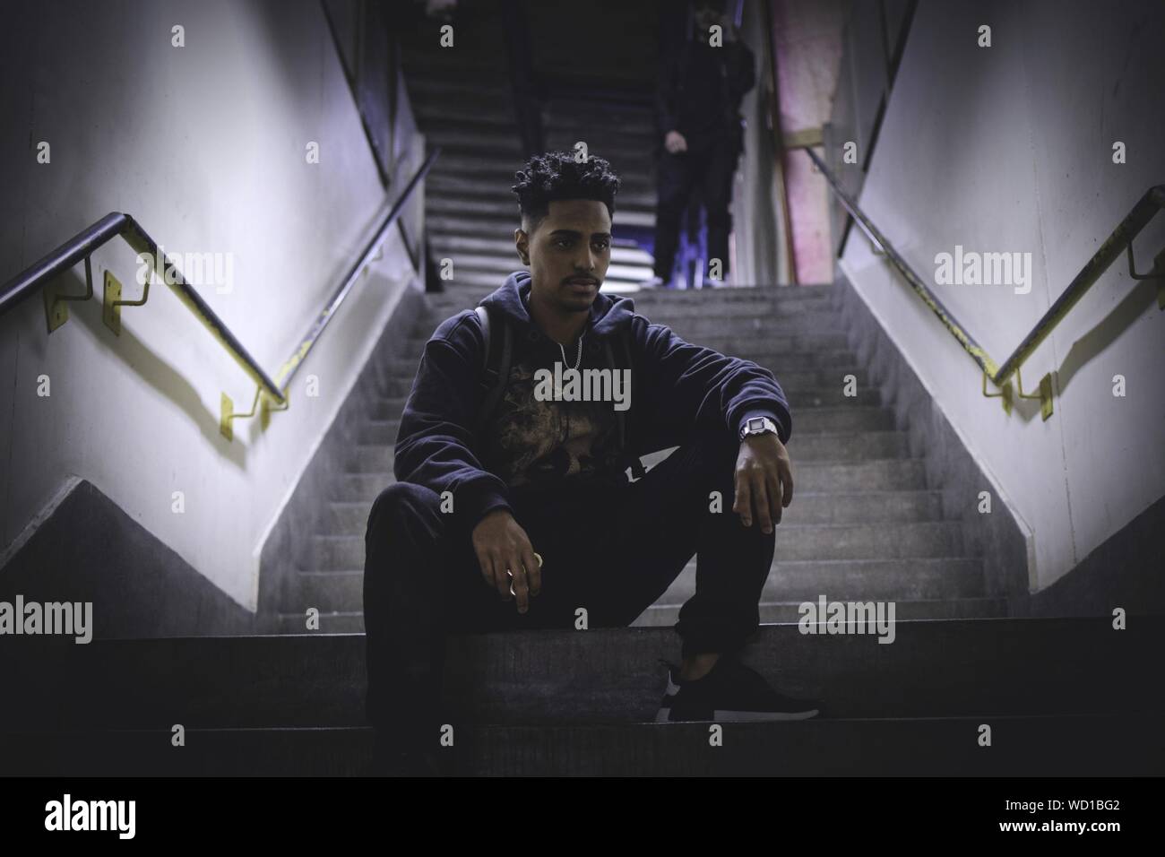 Man sitting on staircase hi-res stock photography and images - Alamy