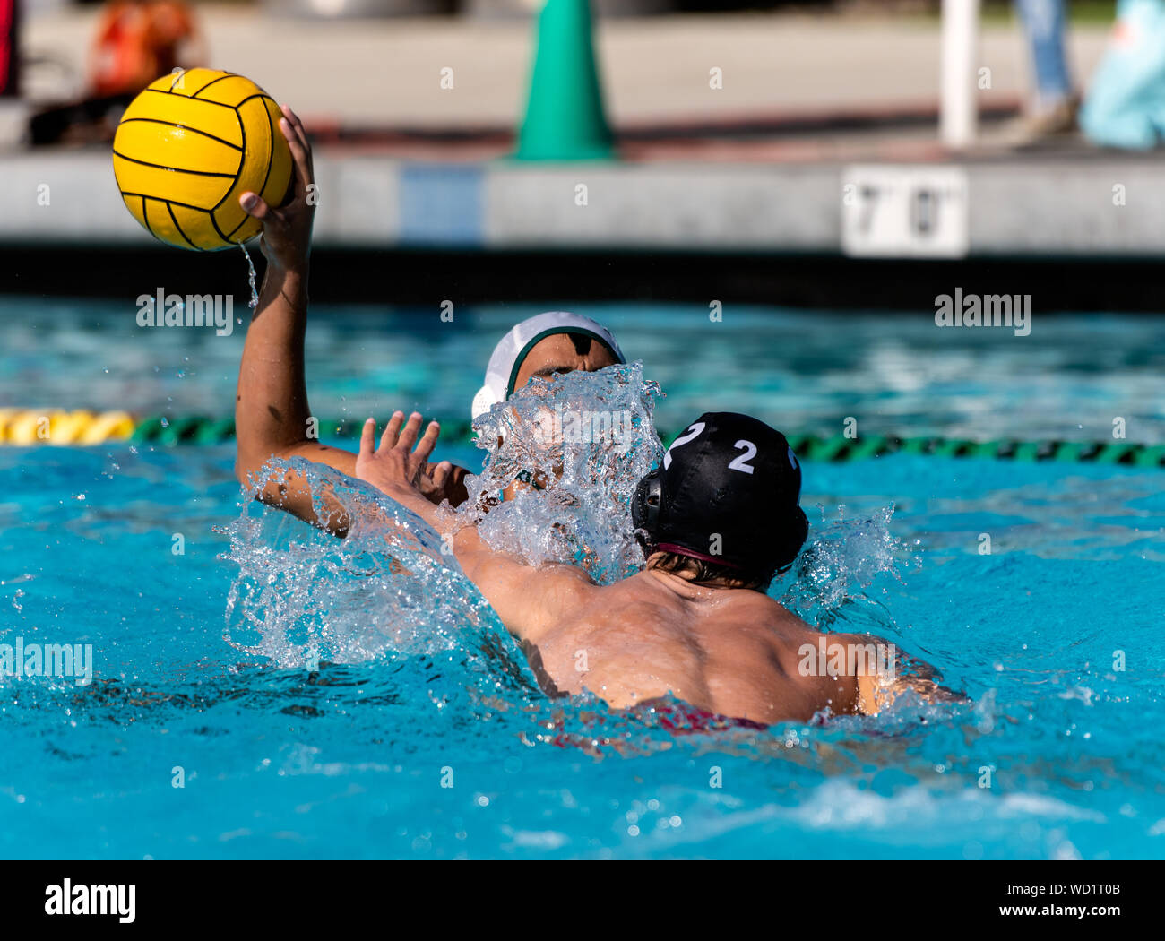 Offensive player in white uniform having water spashed in face as ...